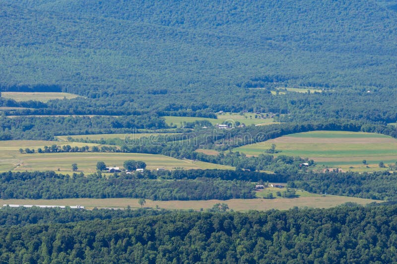 High Angle View of Fields and Farms in the Valley Surrounded by Trees ...