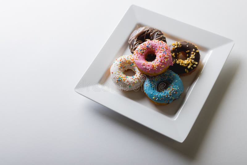 High Angle View of Fresh Multi Colored Donuts in Square Plate by Copy ...