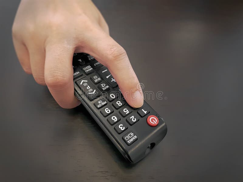 High Angle View of Hand Holding Remote Controller Stock Image - Image ...