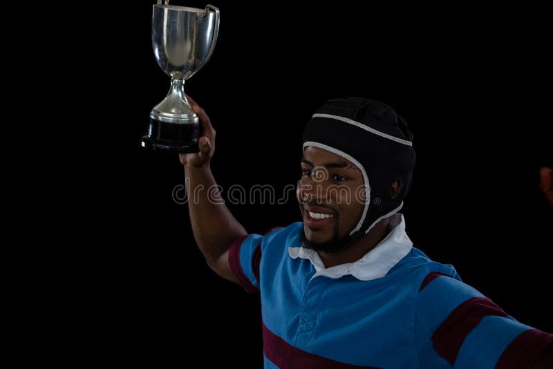 High Angle View of Happy Rugby Player Holding Trophy Stock Photo ...