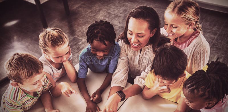 High Angle View of Happy Teacher and Pupils Using Tablet Pc Stock Photo ...