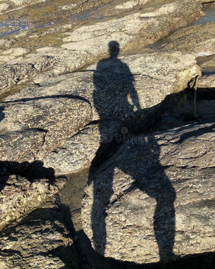 High Angle View of Human Shadow on Rock Stock Image - Image of coast ...