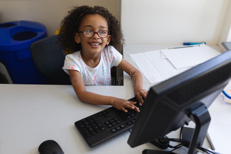 High Angle View Little Schoolgirl Using Desktop Pc at Desk in Classroom ...