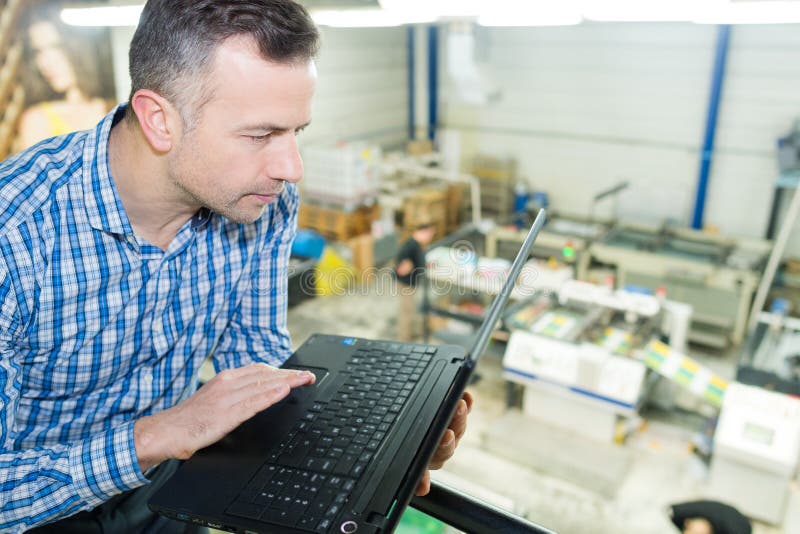 High Angle View Man Using Laptop Above Printing Works Stock Image ...