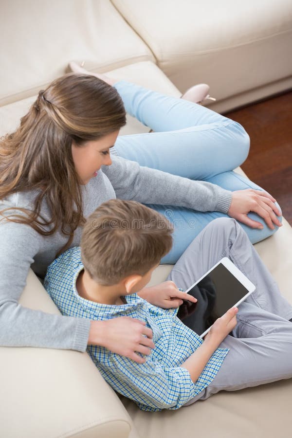 High Angle View of Mother and Son Using Tablet PC on Sofa Stock Photo ...