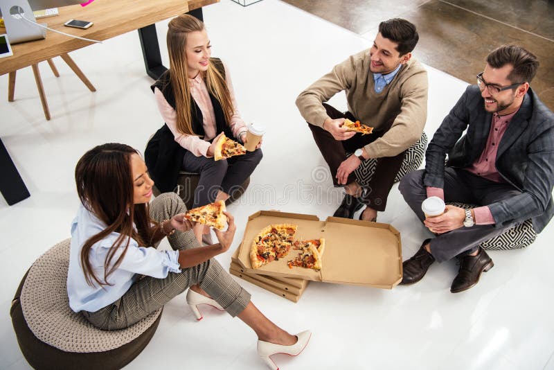 High Angle View of Multiethnic Business People Eating Pizza Stock Image ...