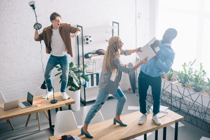 High Angle View of Multiethnic Two Colleagues Fighting on Table in ...