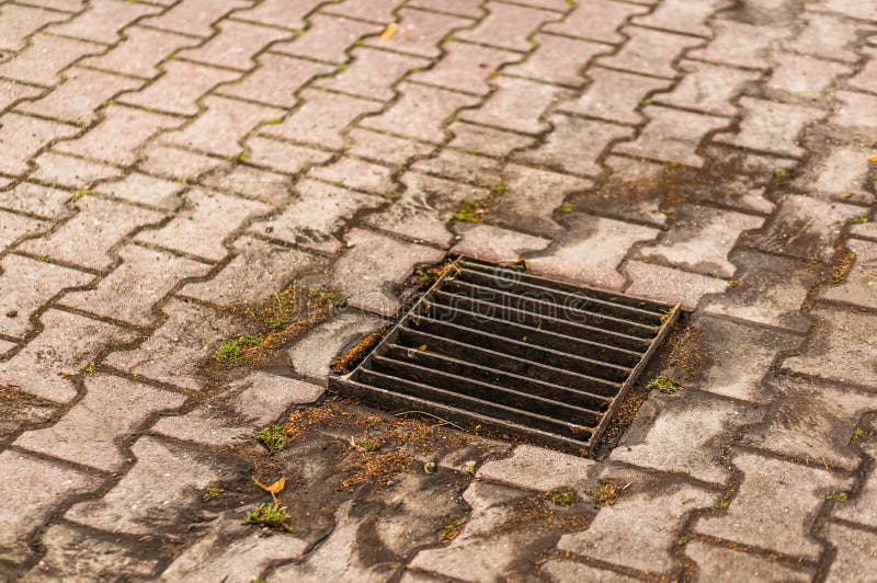 High Angle View of an Old Drain Grate on the Ground Under the Sunlight ...