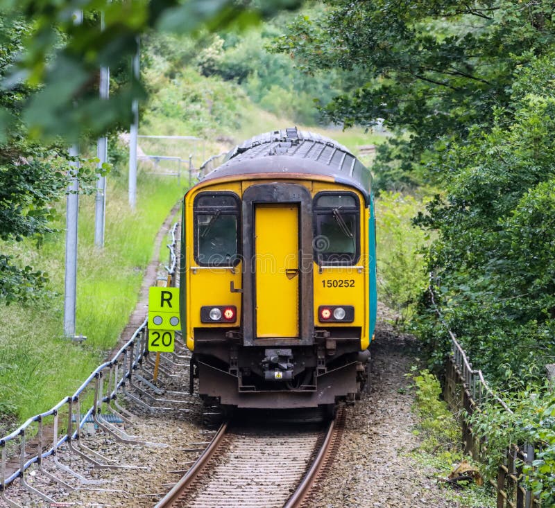High-angle View of an Old Yellow Train Over the Rails Passing through ...