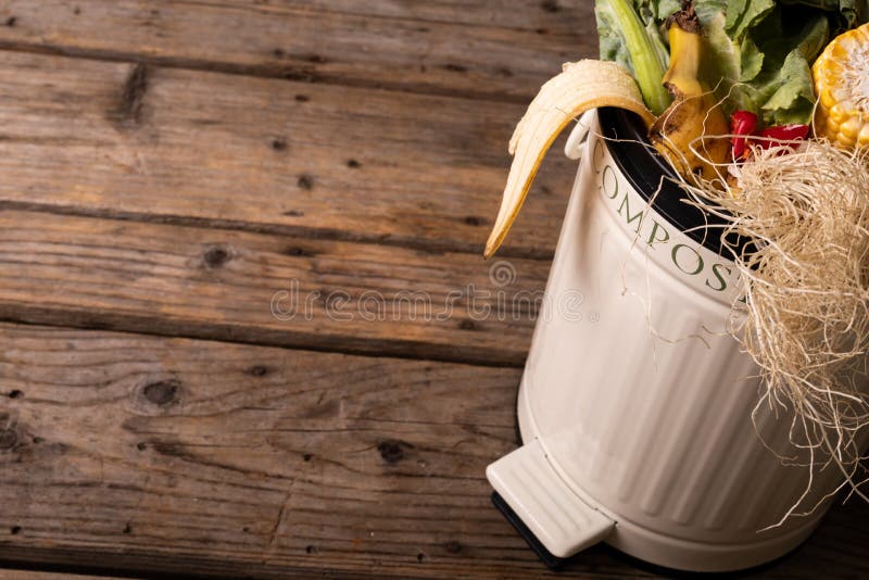 High Angle View of Organic Waste in White Compost Bin on Wooden Table ...
