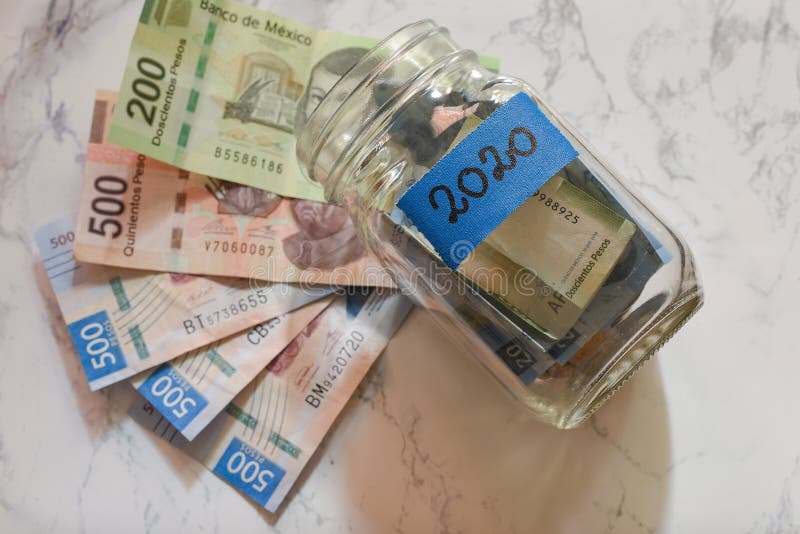 High Angle View of Pesos in a Jar with a Blue [2020] Sticker on it on ...
