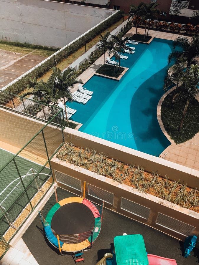 High Angle View of a Pool Surrounded by Sport Game Courts Under ...