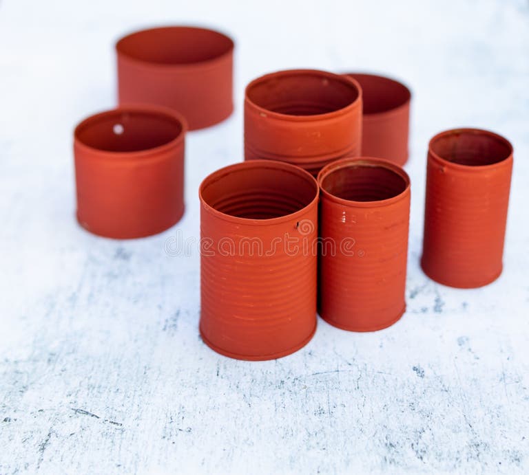 High Angle View of Red Cans in Different Sizes on the Table Under the ...