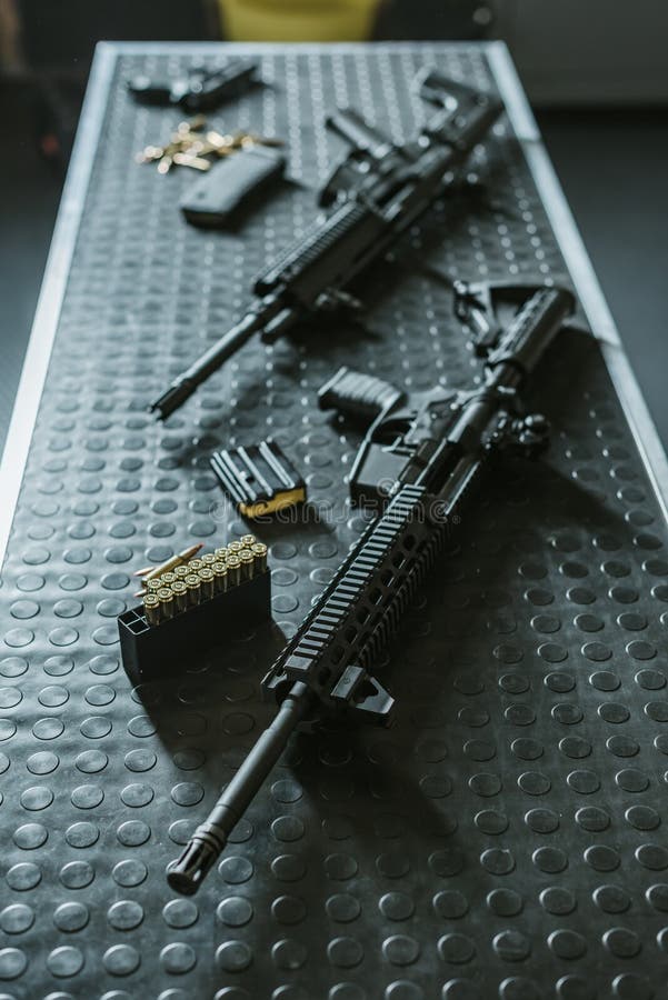 High Angle View of Rifles with Bullets on Table in Shooting Range Stock ...