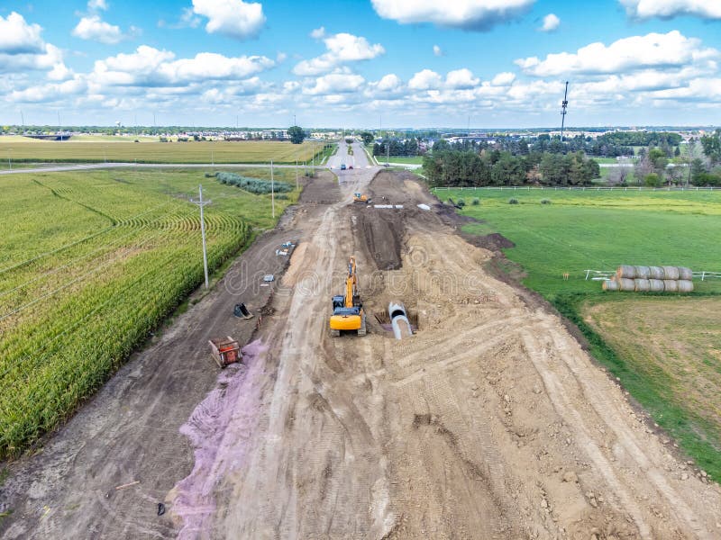 High Angle View of a Road Construction Project Starting in a Corn Field ...