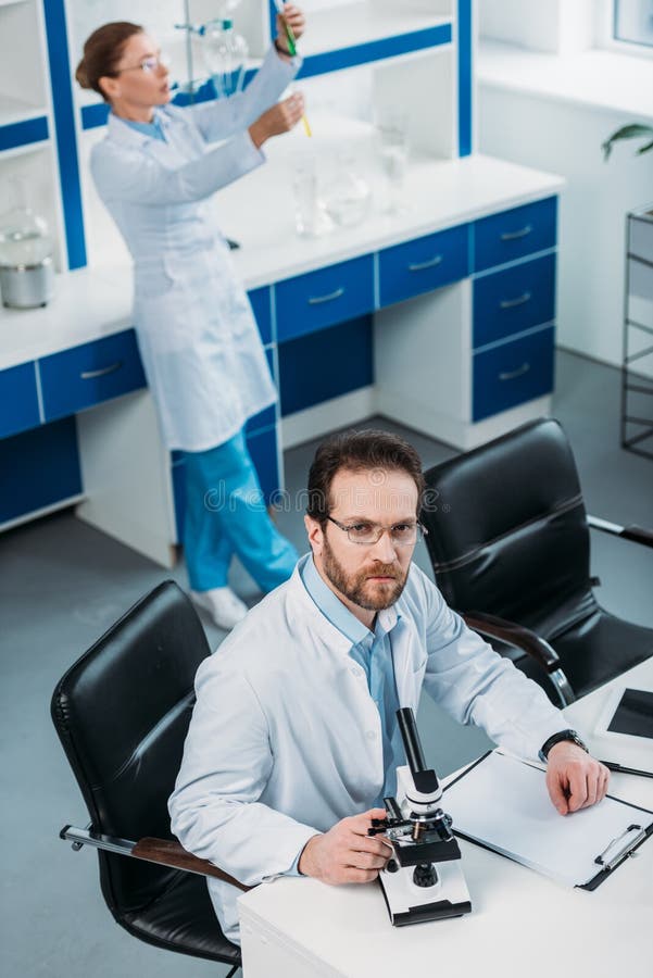 High Angle View of Scientist in White Coat at Workplace with Microscope ...