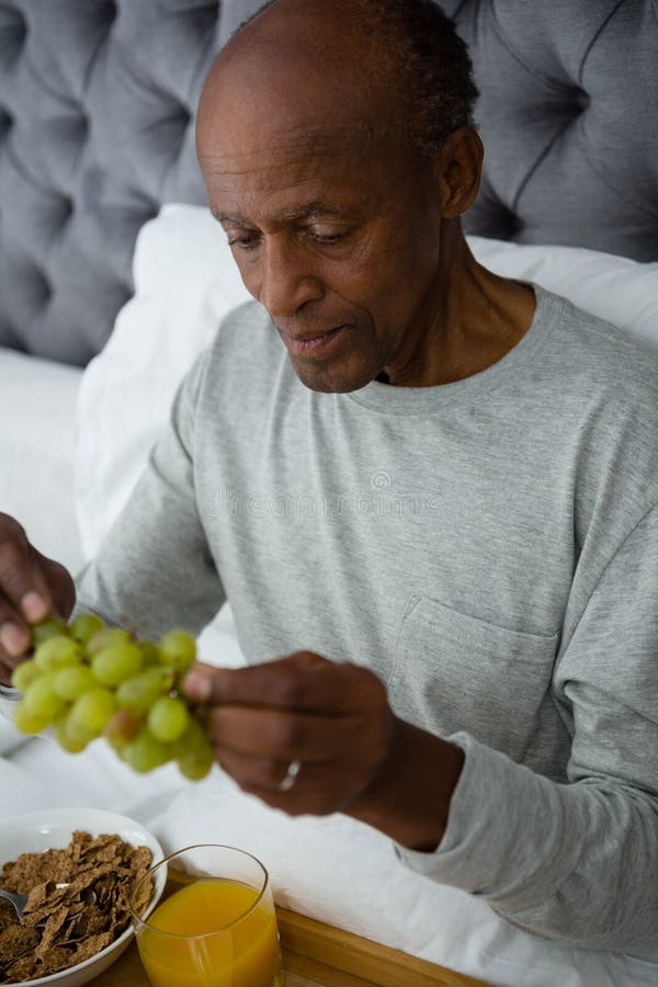 High Angle View of Senior Man Having Breakfast on Bed Stock Photo ...