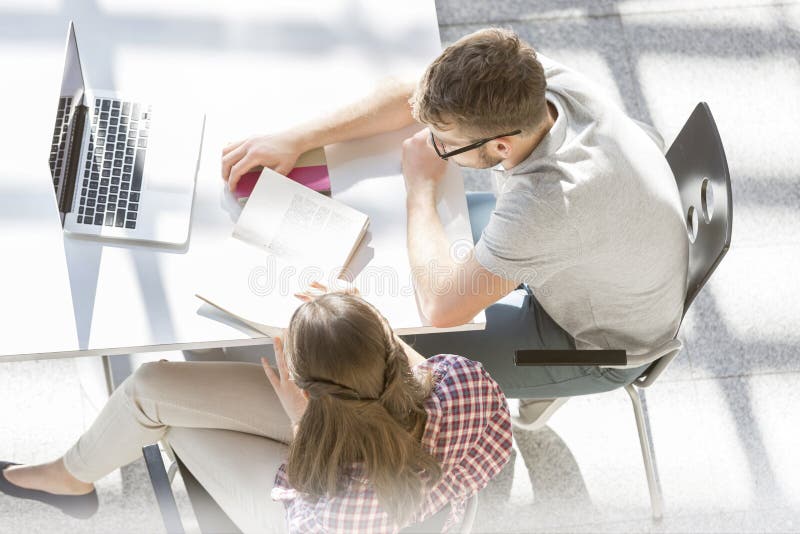 High Angle View of Students Working on Assignment at Library Stock ...