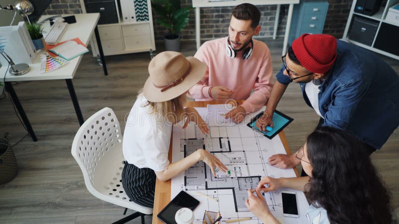 High Angle View of Successful Experts Discussing Project Then Joining ...