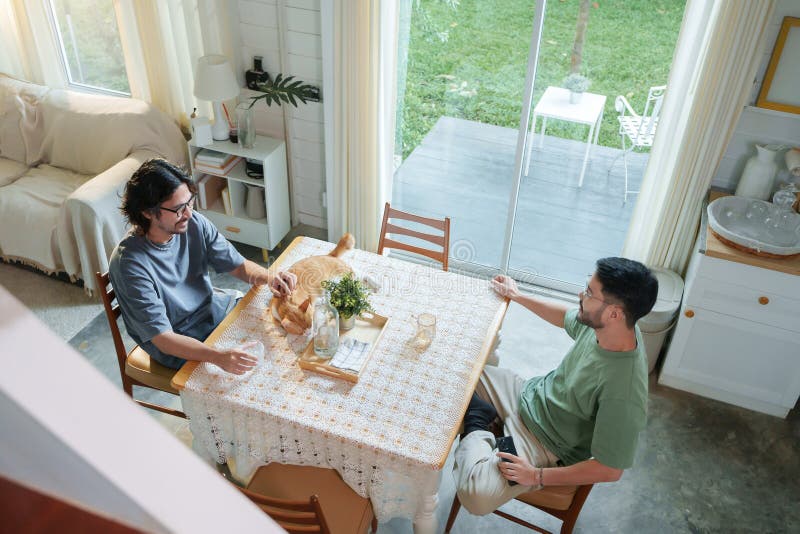 High Angle View of Two Asian Men Sitting at a Dining Table Stock Photo ...