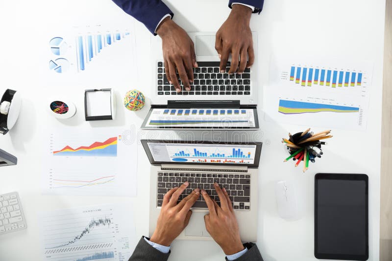 Two Businesspeople Analyzing Graph on Laptop Stock Photo - Image of ... Two Businesspeople Analyzing Graph on Laptop Stock Photo - Image of ...