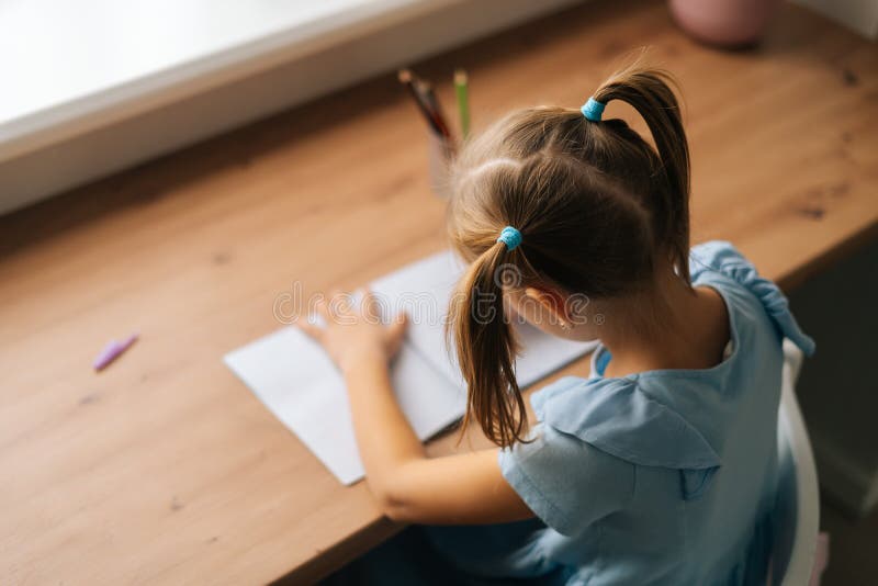 High-angle View of Unrecognizable Little Child Girl Learning Writing ...