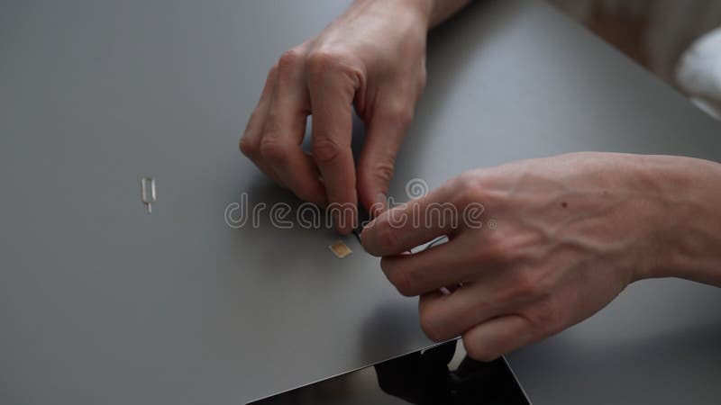 High-angle View of Unrecognizable Man Using Sim Ejector Tool To Remove ...