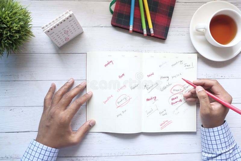 Top View of Man Hand Writing on Weekly Planner on Table. Stock Image ...