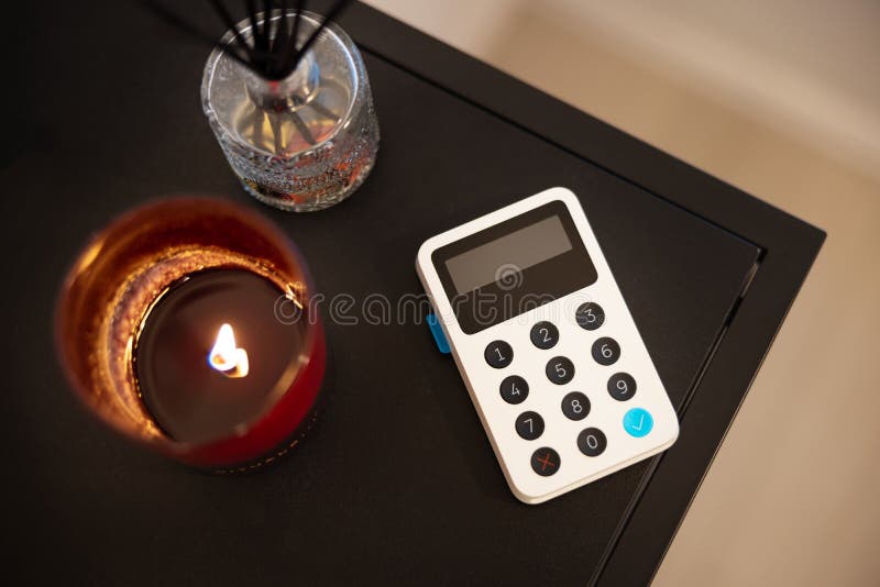 White Card Reader by Tealight on Table Stock Photo - Image of table ...