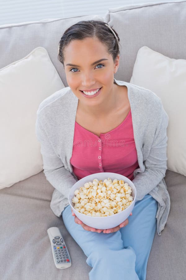 High Angle View of Woman Sitting on Sofa Holding Popcorn Stock Image ...