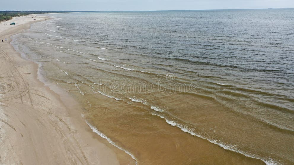 High-angle View of a Yellow and Blue Colored Sea Beach with Light Waves ...
