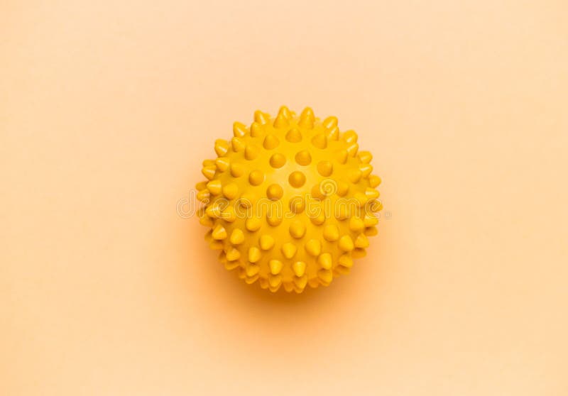 High-angle View of a Yellow Spikey Ball Over the Orange Background ...