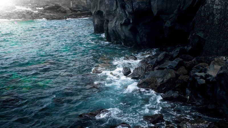 High Black Volcanic Cliffs and Rockes on the Ocean Coast Stock Image ...