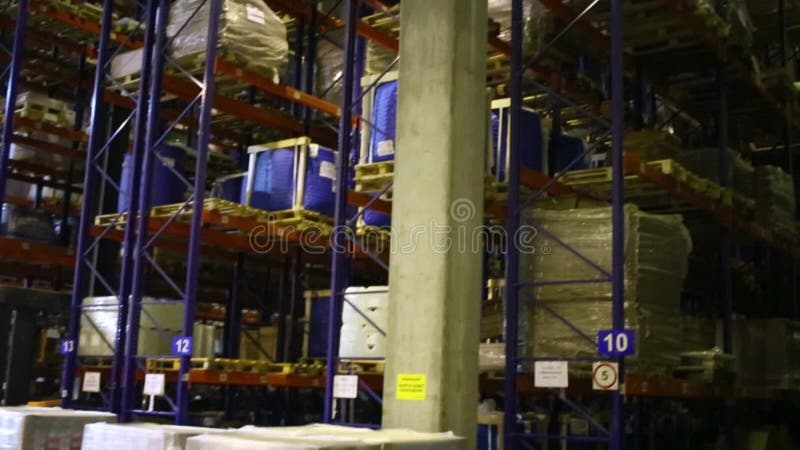 High-ceilinged Storage Racks with Pallets of Goods Stock Footage ...
