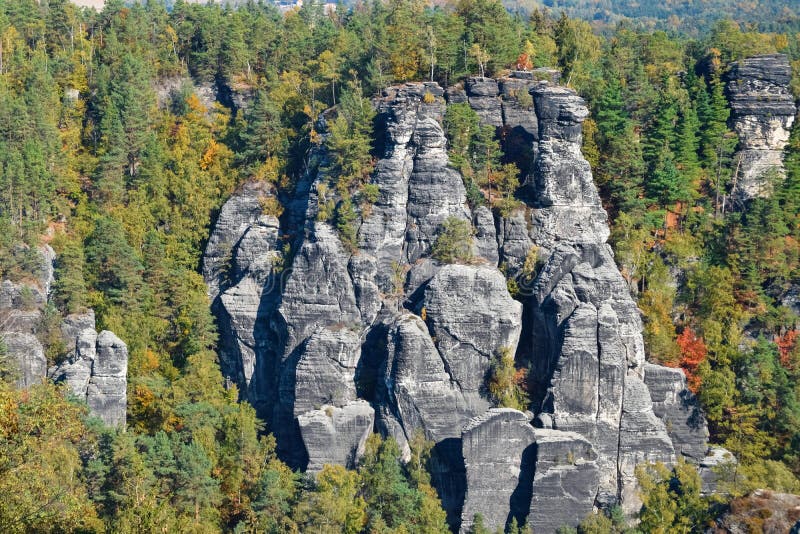 High Cliffs Under the Rays of the Sun and Coniferous Forest Stock Image ...