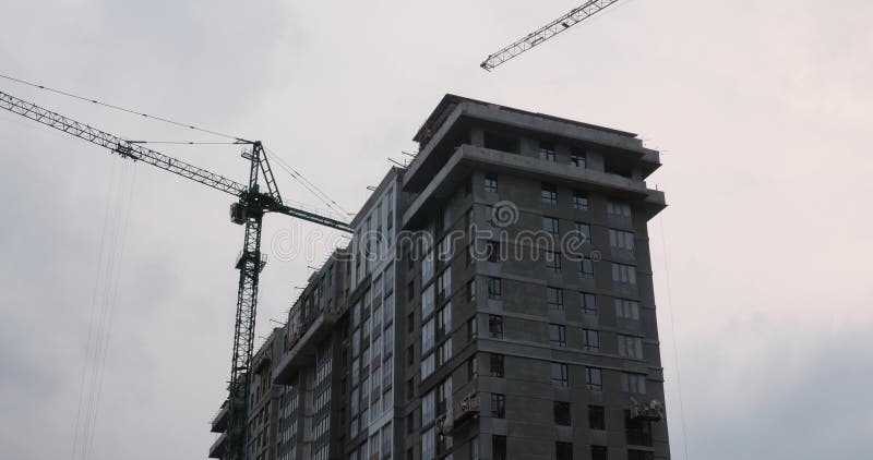 High Crane Working on Construction Site of Skyscraper. Construction of ...