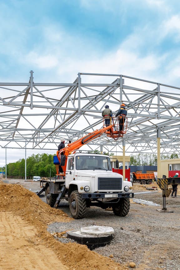 High Elevated Cherry Picker People are Working at New Assembled ...