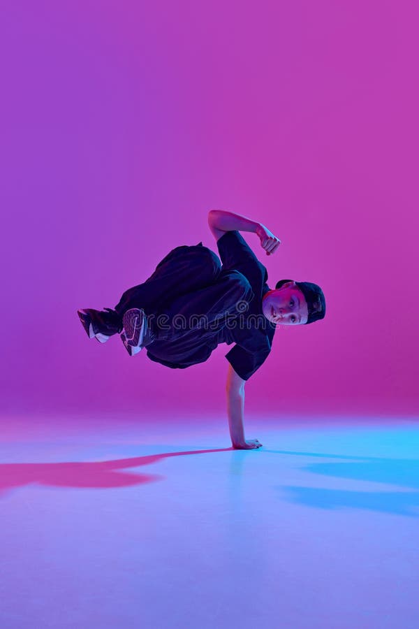 High-energy Dance. Young Boy Executing a Complex Dance Move in Mixed ...