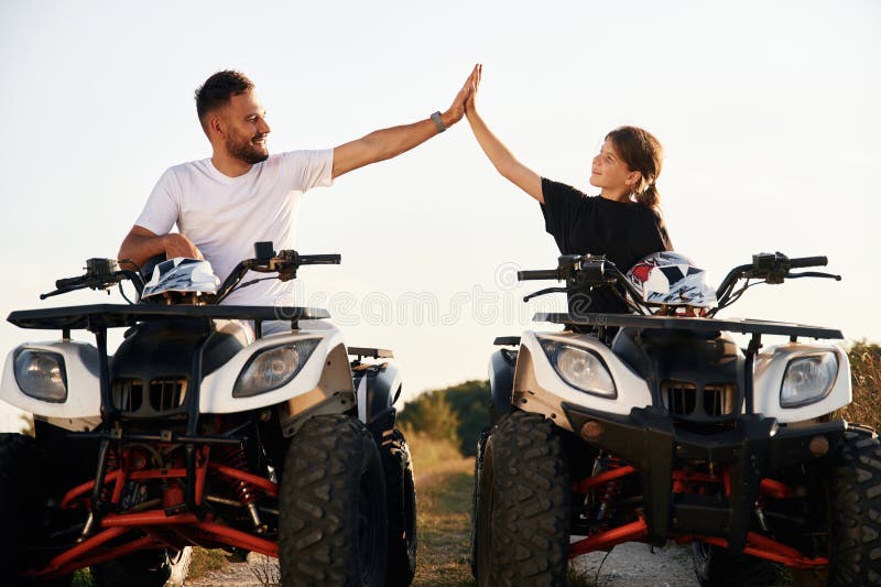 High Five Gesture. Father and Daughter are with ATV Outdoors Stock ...