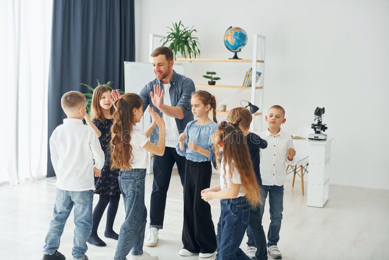 High Fives Gesture. Group of Children Students in Class at School with ...