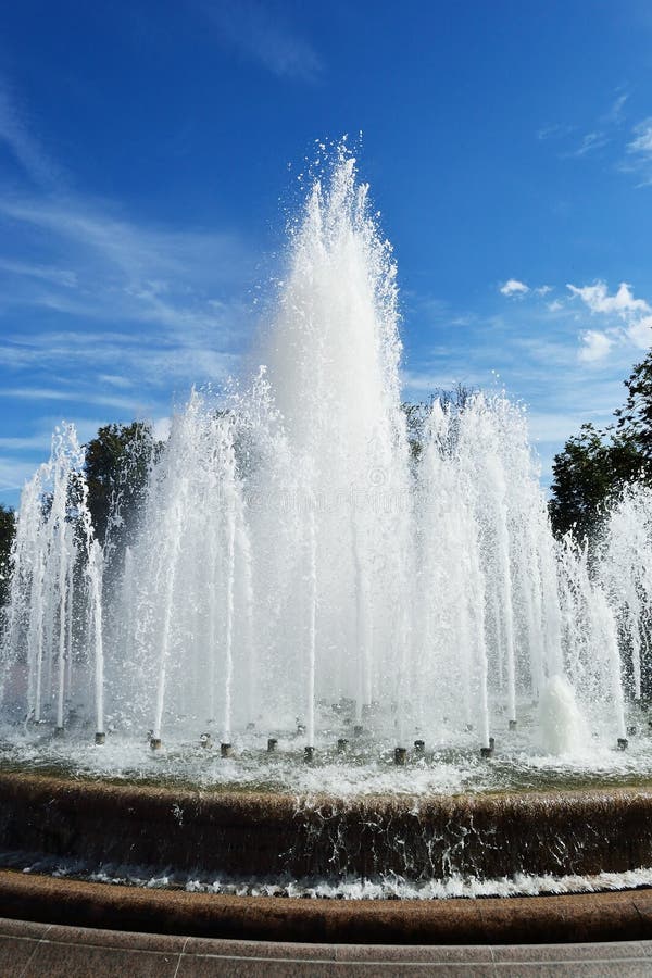 High Fountain Spraying Water in the Park. Fountain Spray System Stock ...