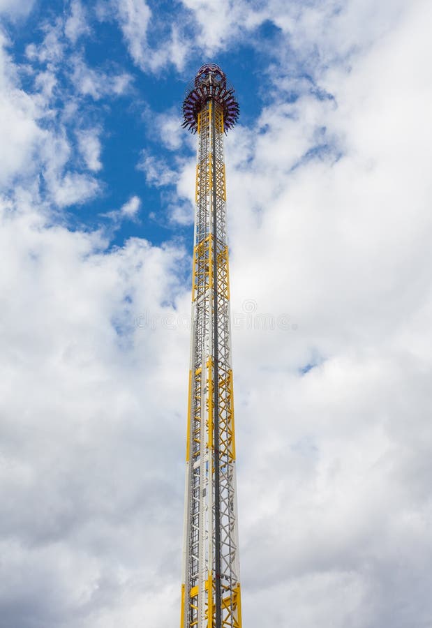 High Free Fall Tower in an Amusement Park with Blue Sky and Clou Stock ...