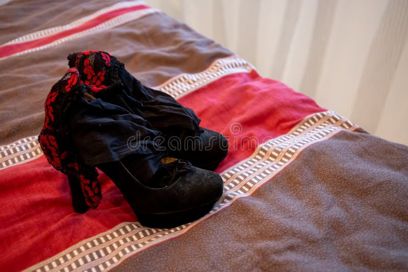 High Heels and Stockings on the Ceiling of a Bed Stock Image - Image of ...