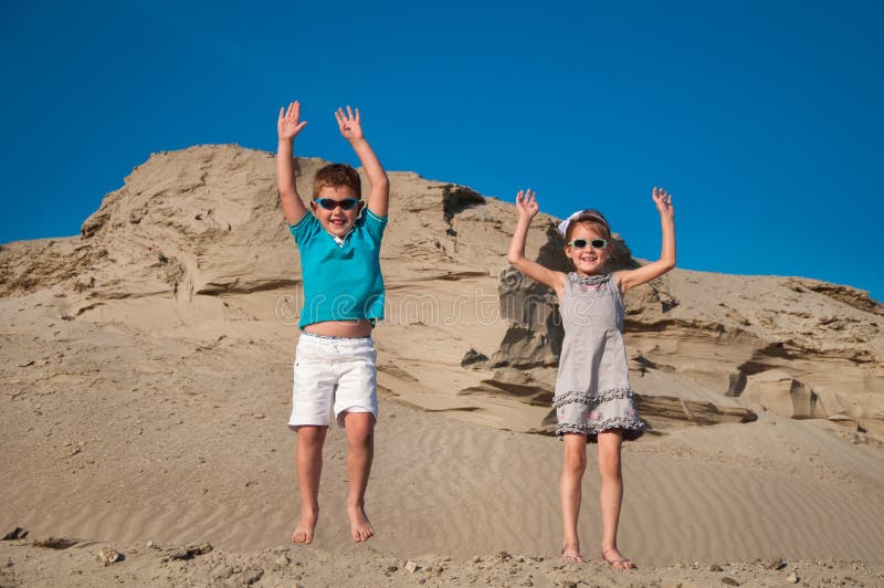 Children jumping on beach stock image. Image of leisure - 13684243