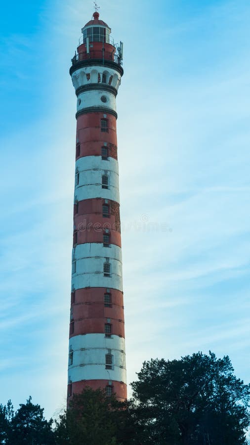 High Lighthouse in the Forest Landscape. Red and White Lighthouse Stock ...