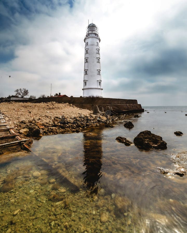 High Lighthouse on the Seashore Stock Photo - Image of lighthouse ...
