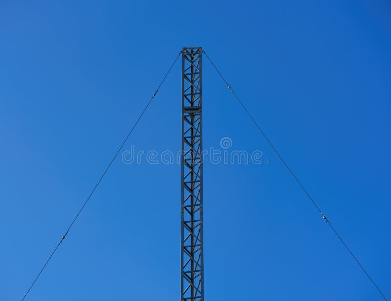High Metal Tower with a Stay Ropes Against Blue Sky Stock Photo - Image ...