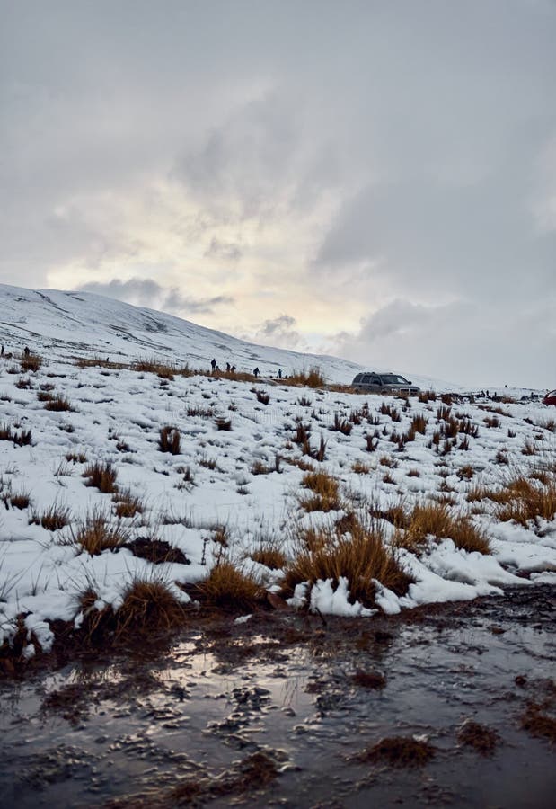 High Mountain Covered in Snow Gleaming Under the Cloudy Sky in Winter ...