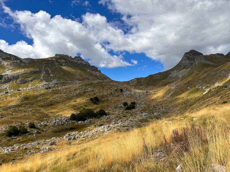 High Mountain Landscape with Two Mountain Peaks, Clouds, Yellow Shrubs ...