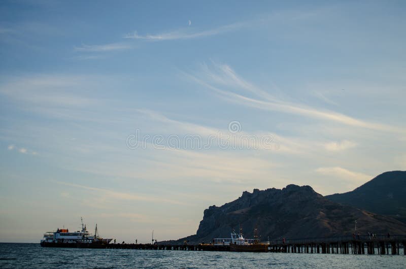 High Mountains and a Wooden Pier on the Sea Coast Editorial Photography ...